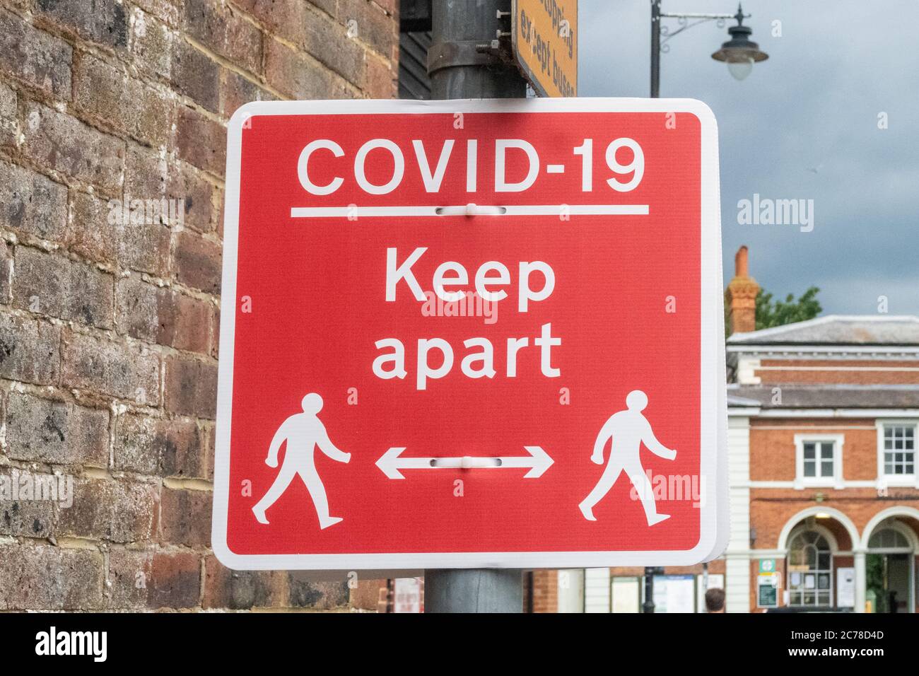A sign warning of Covid-19 and instructing people to keep their ...