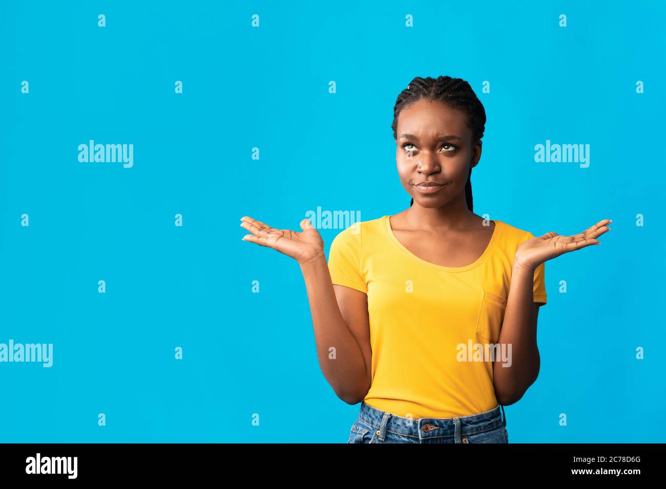 Girl Comparing Two Invisible Objects On Hands Over Blue Background ...