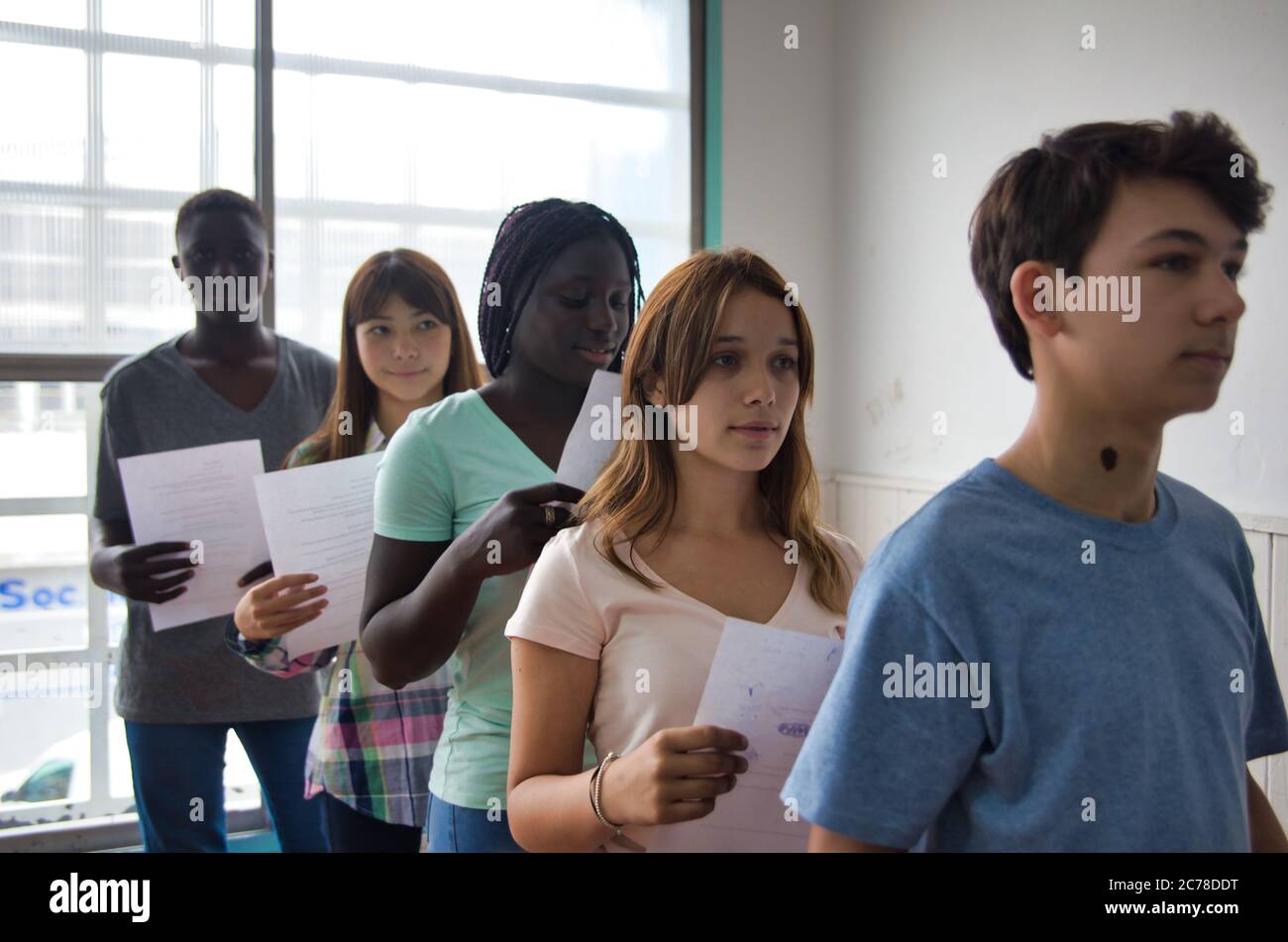 Teenagers at school. Multi ethnic classroom delivering test Stock Photo ...