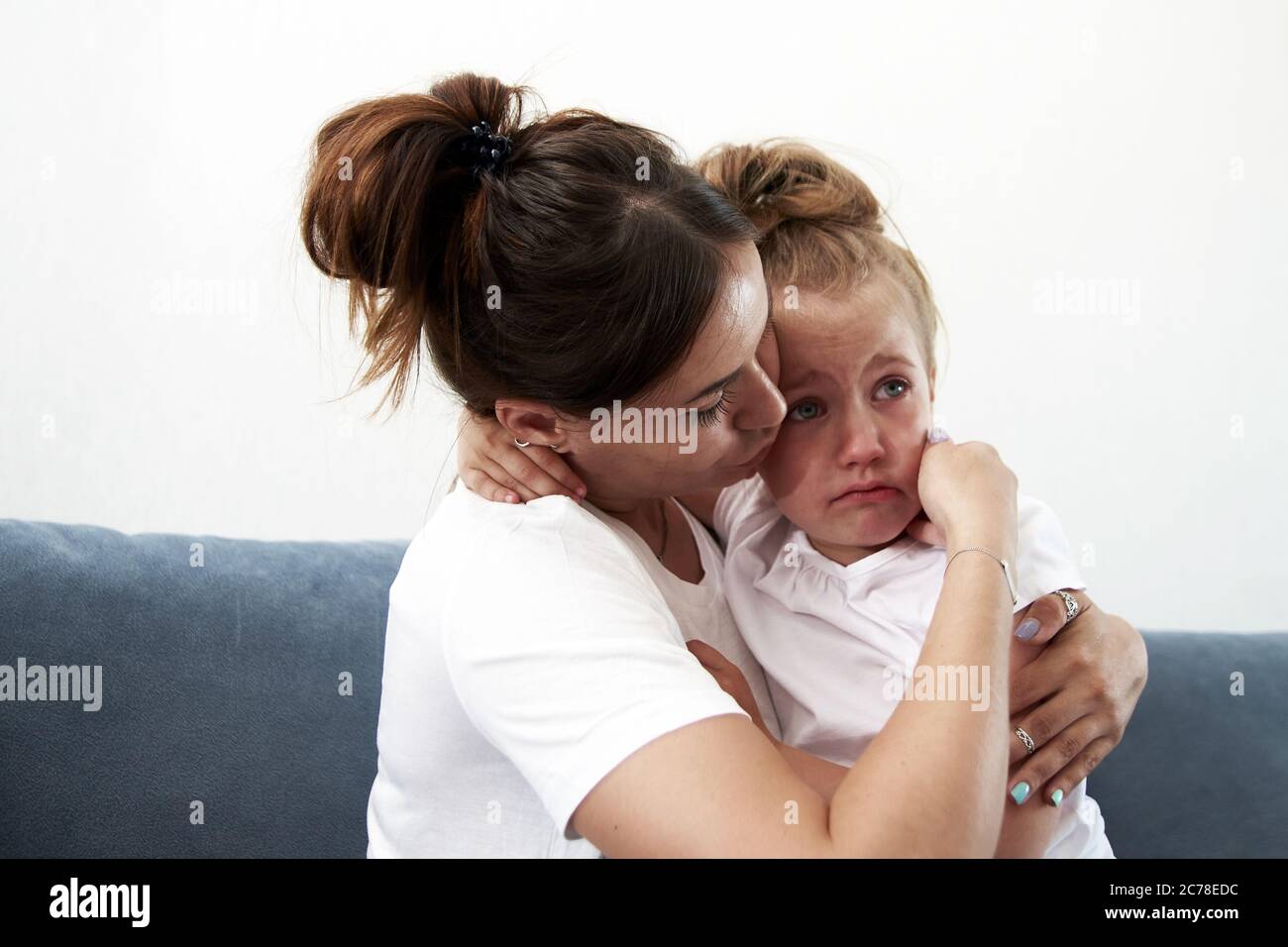 Mother hugging daughter sad hi-res stock photography and images - Alamy