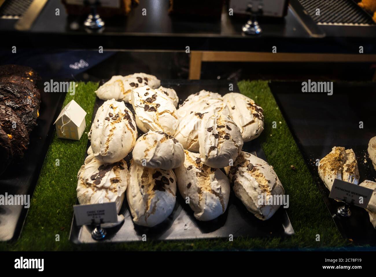 Display of a candy store with a great assortment of meringue cakes in ...