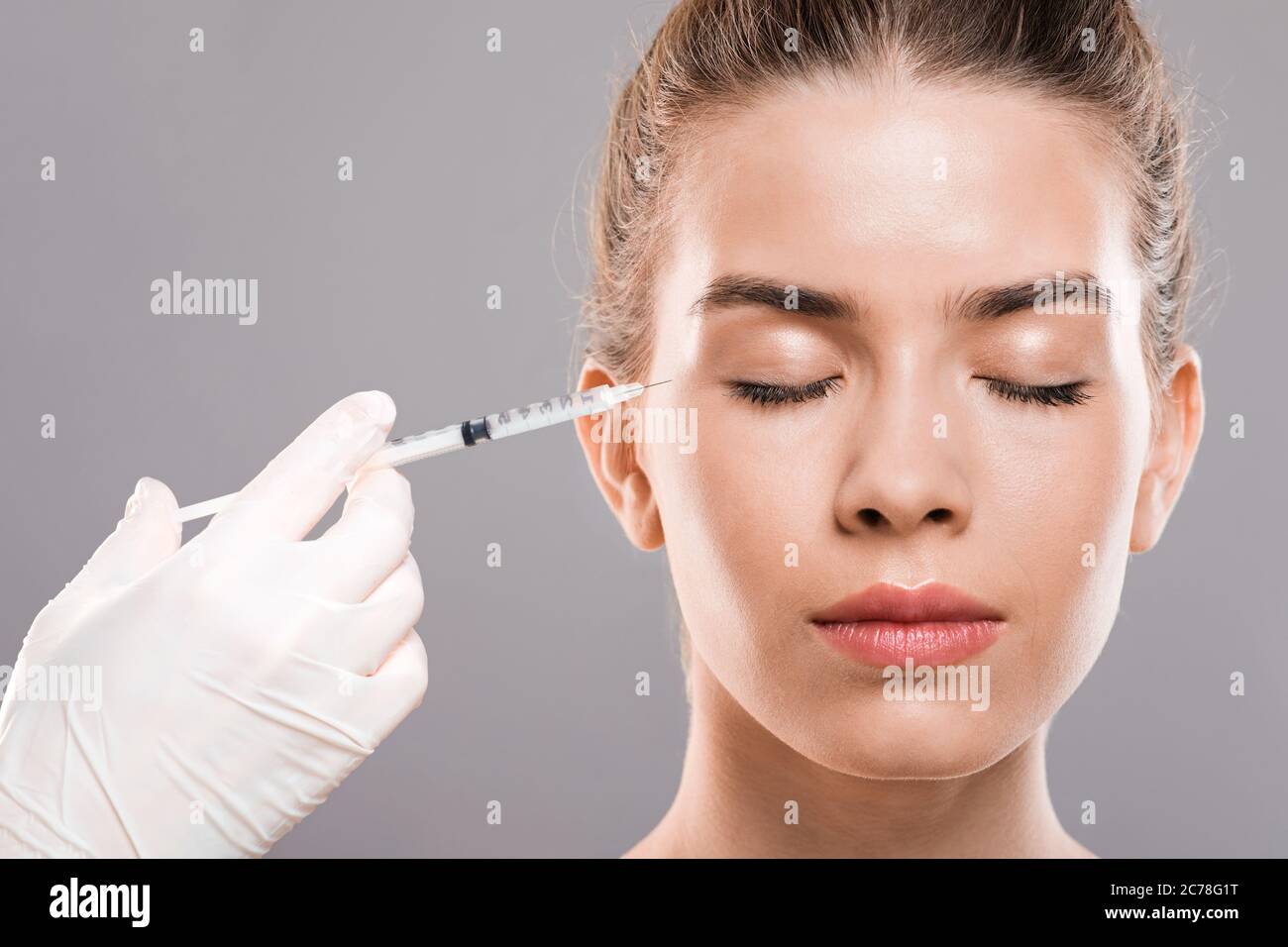 Closeup of young lady having injections for eye wrinkles Stock Photo ...