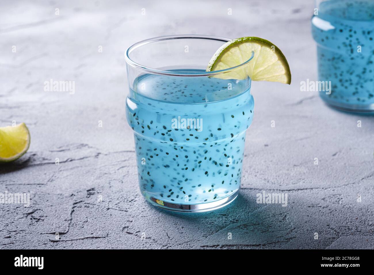Tasty blue colored cocktail drink with basil chia seeds and citrus lime ...