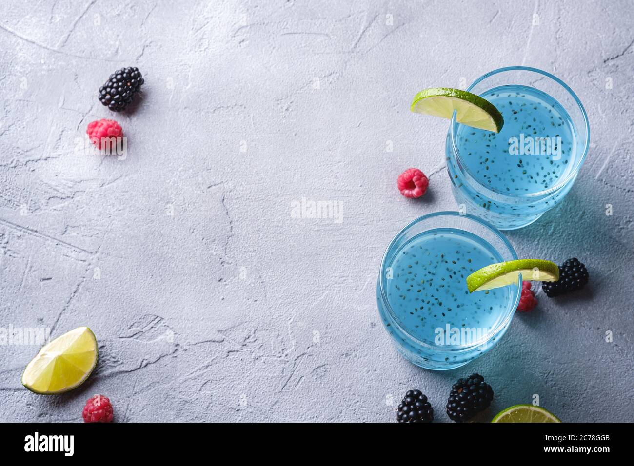 Tasty blue colored cocktail drink with basil chia seeds, citrus lime ...