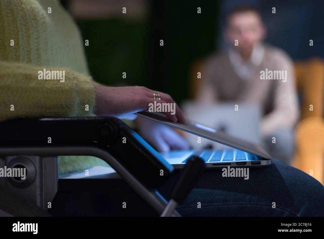 Disabled businesswoman in the wheelchair using her laptop while ...