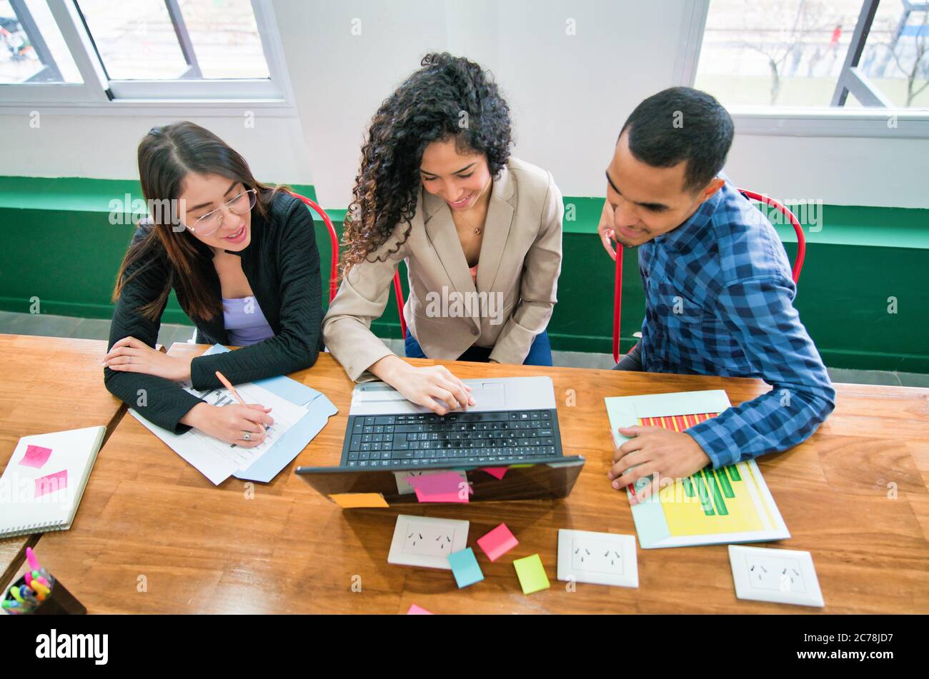 Happy group of young coworkers succeeding at work Stock Photo - Alamy