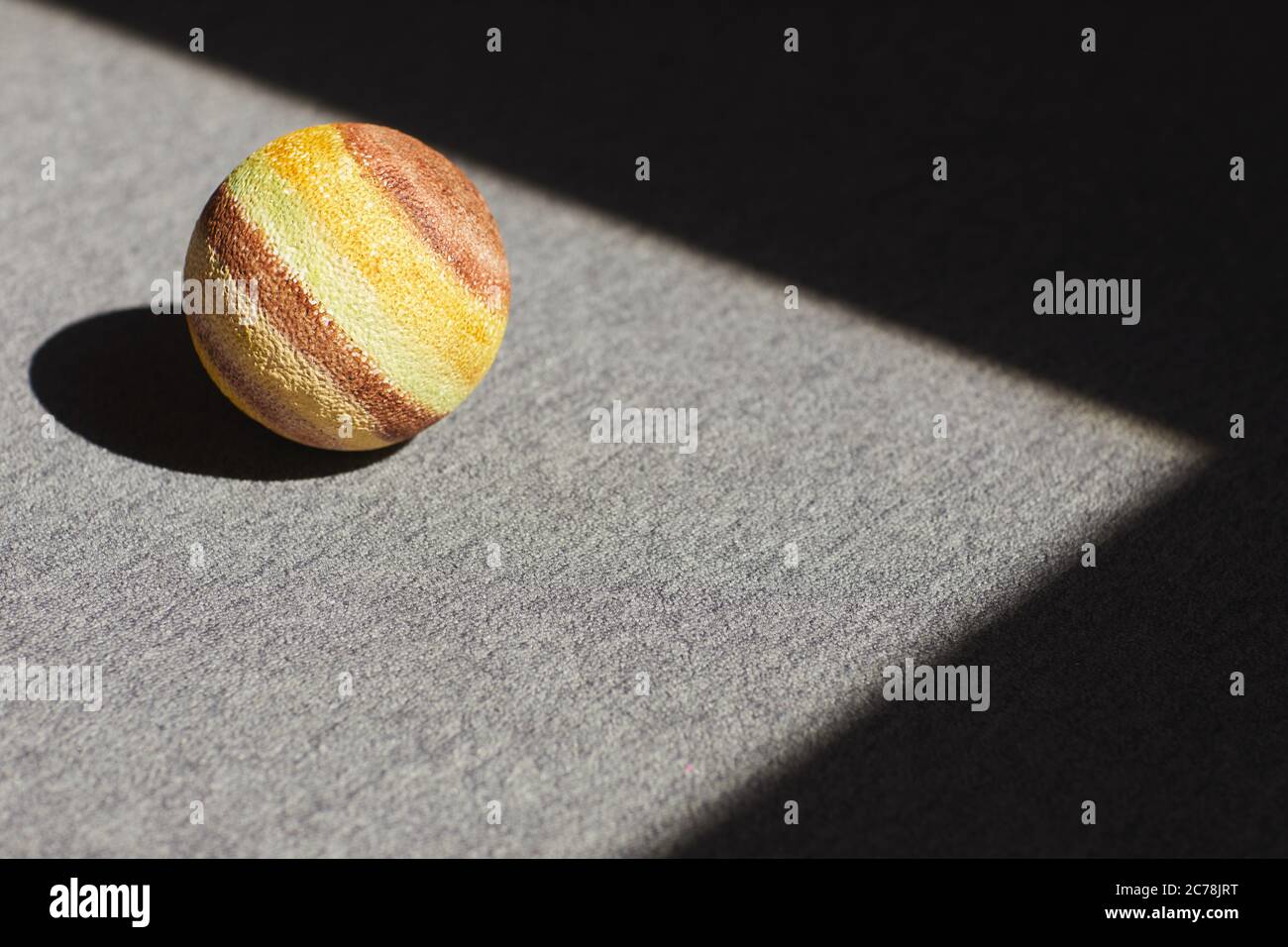 Close-up of Jupiter planet model or small ball placed on floor ...