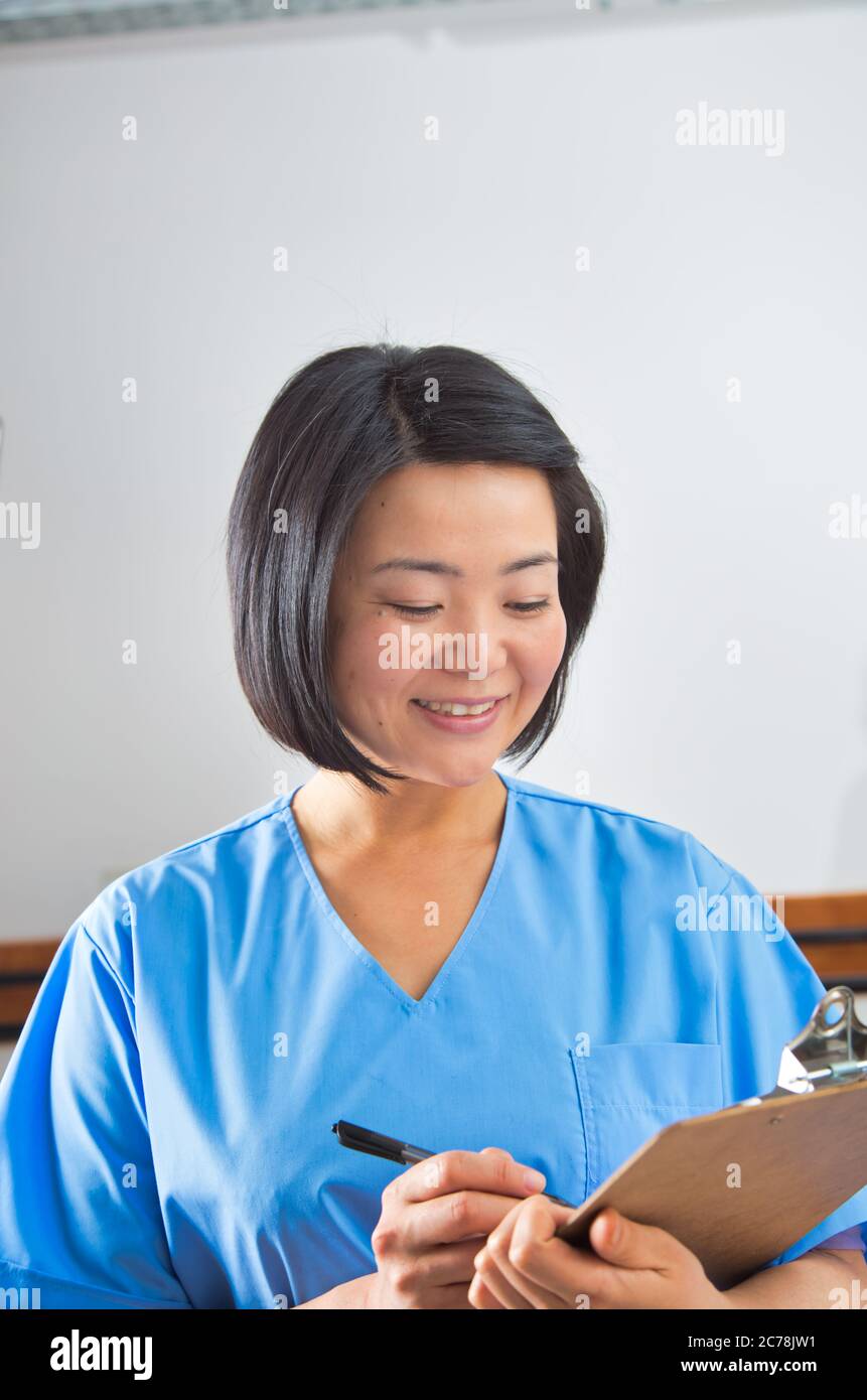 Asian female doctor writing hi-res stock photography and images - Alamy