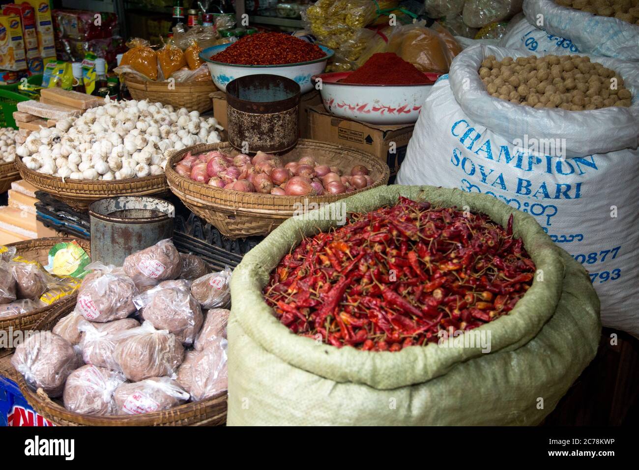 Spices on a market stall in myanmar including sacks of red chilles ...