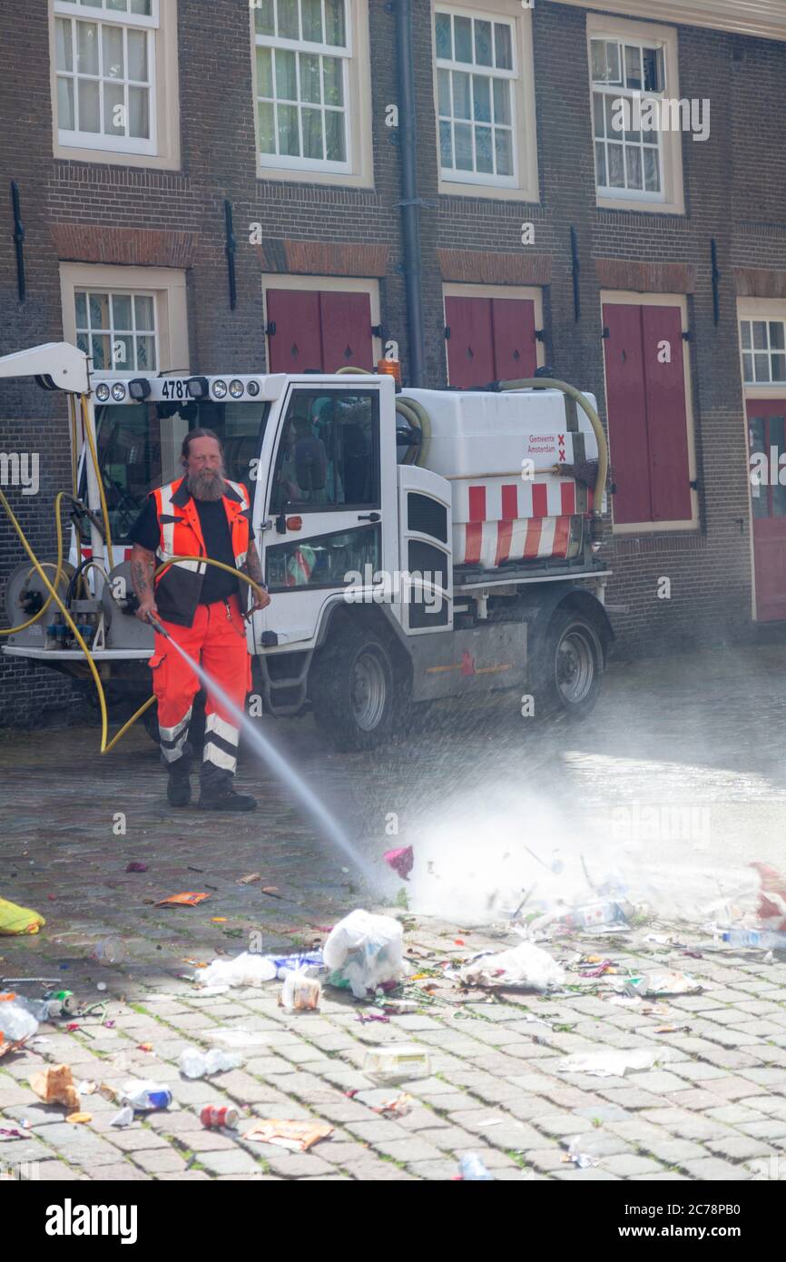a worker of municipality as cleaning the area with water,Amsterdam ...