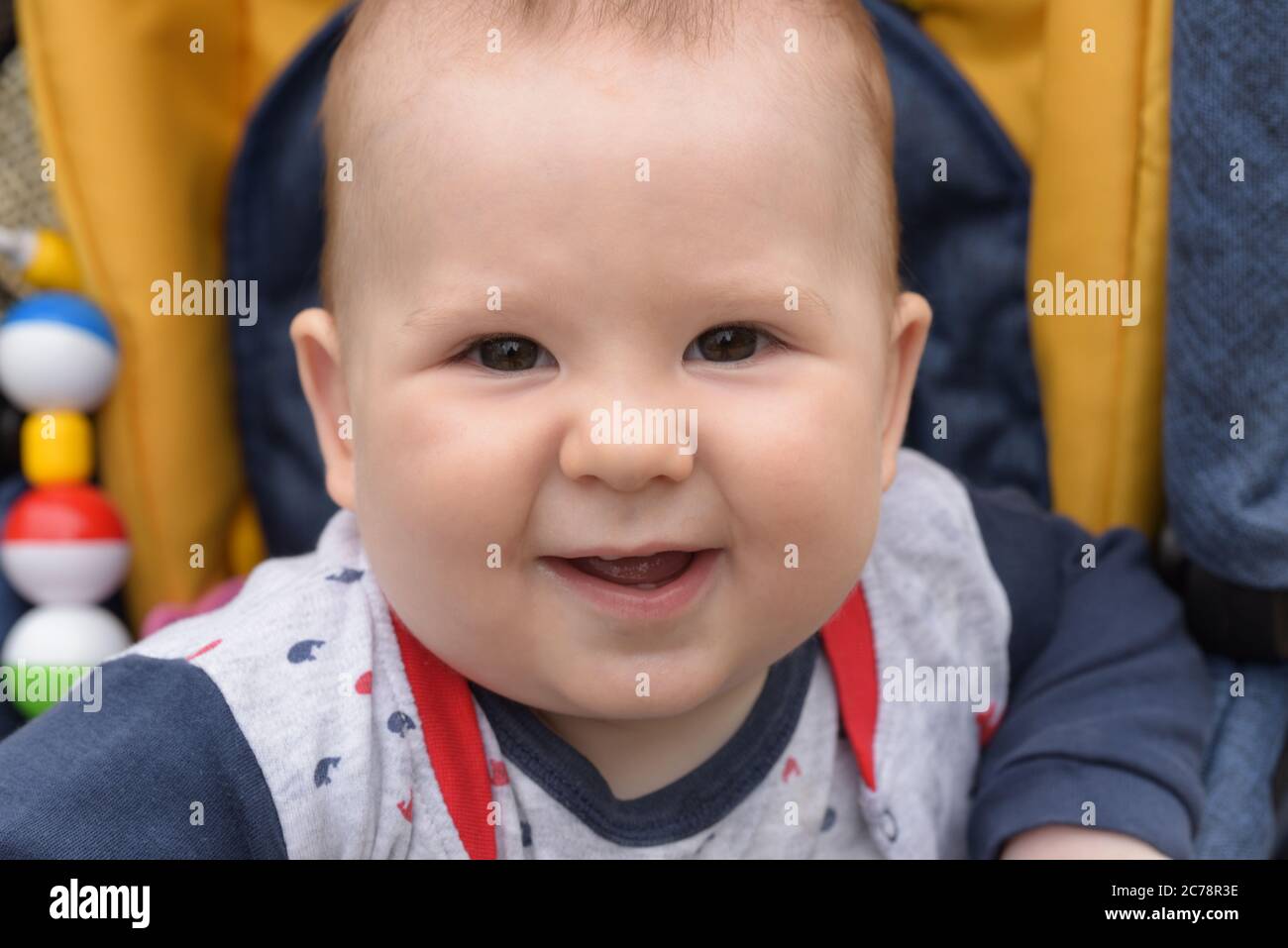 Baby sitting in stroller. Face of little boy Stock Photo - Alamy