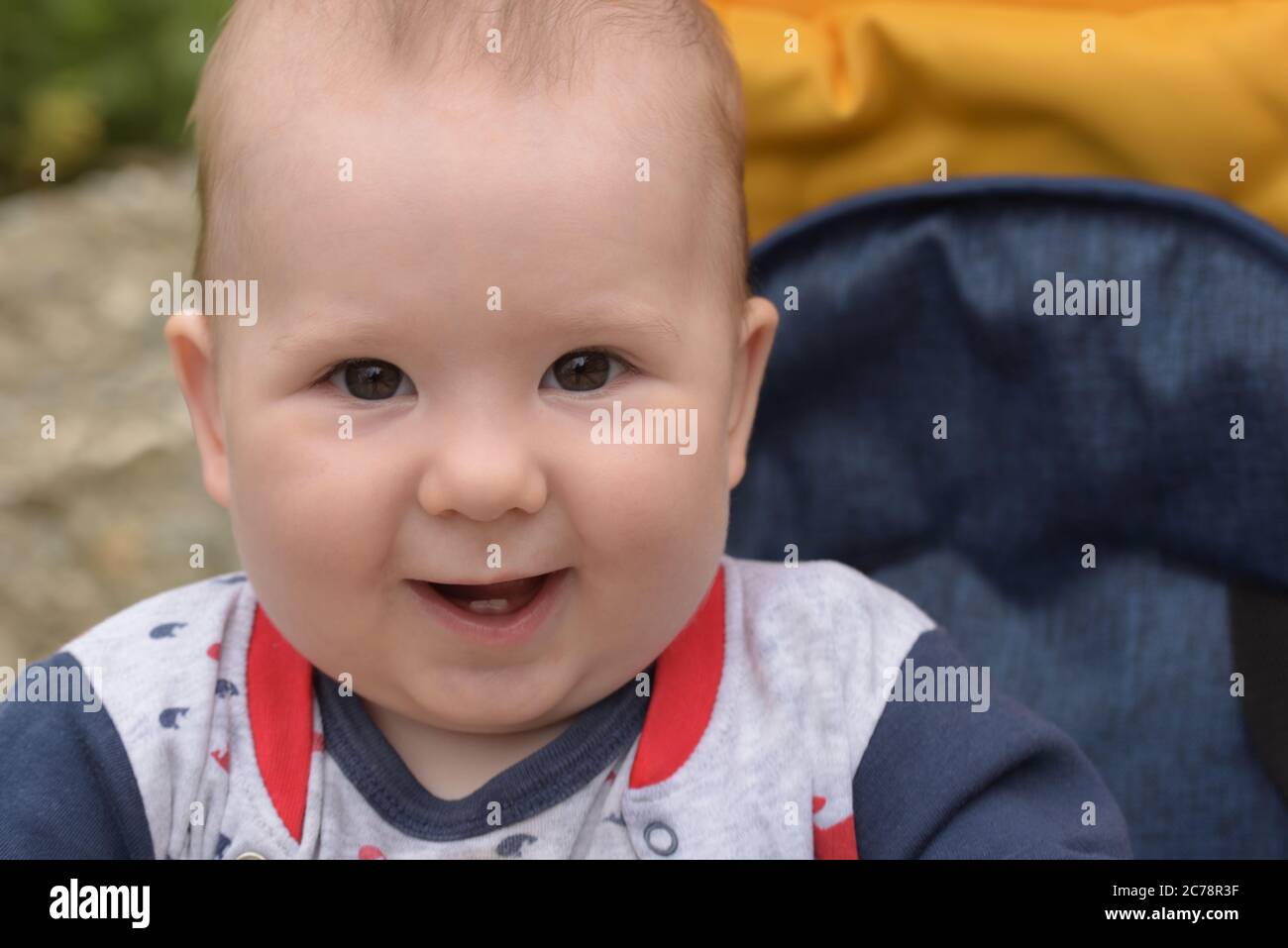 Baby sitting in stroller. Face of little boy Stock Photo - Alamy