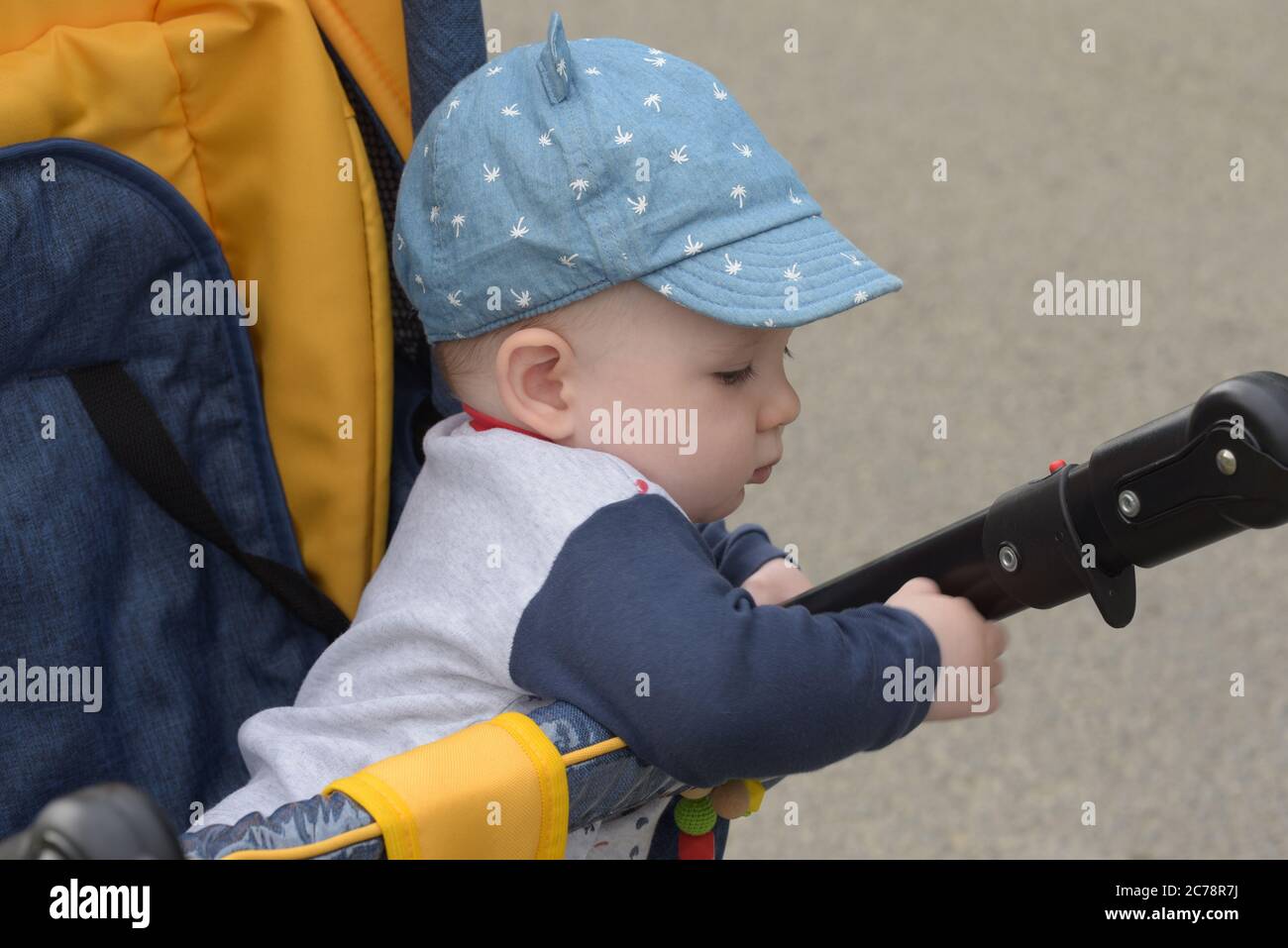 Baby sitting in stroller. Face of little boy Stock Photo - Alamy