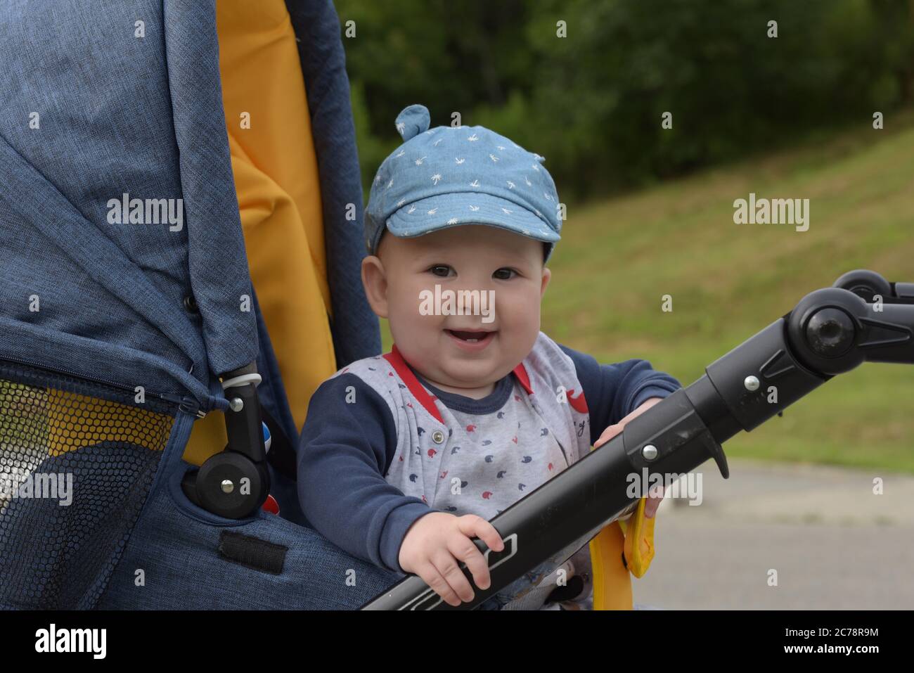 Baby sitting in stroller. Face of little boy Stock Photo - Alamy
