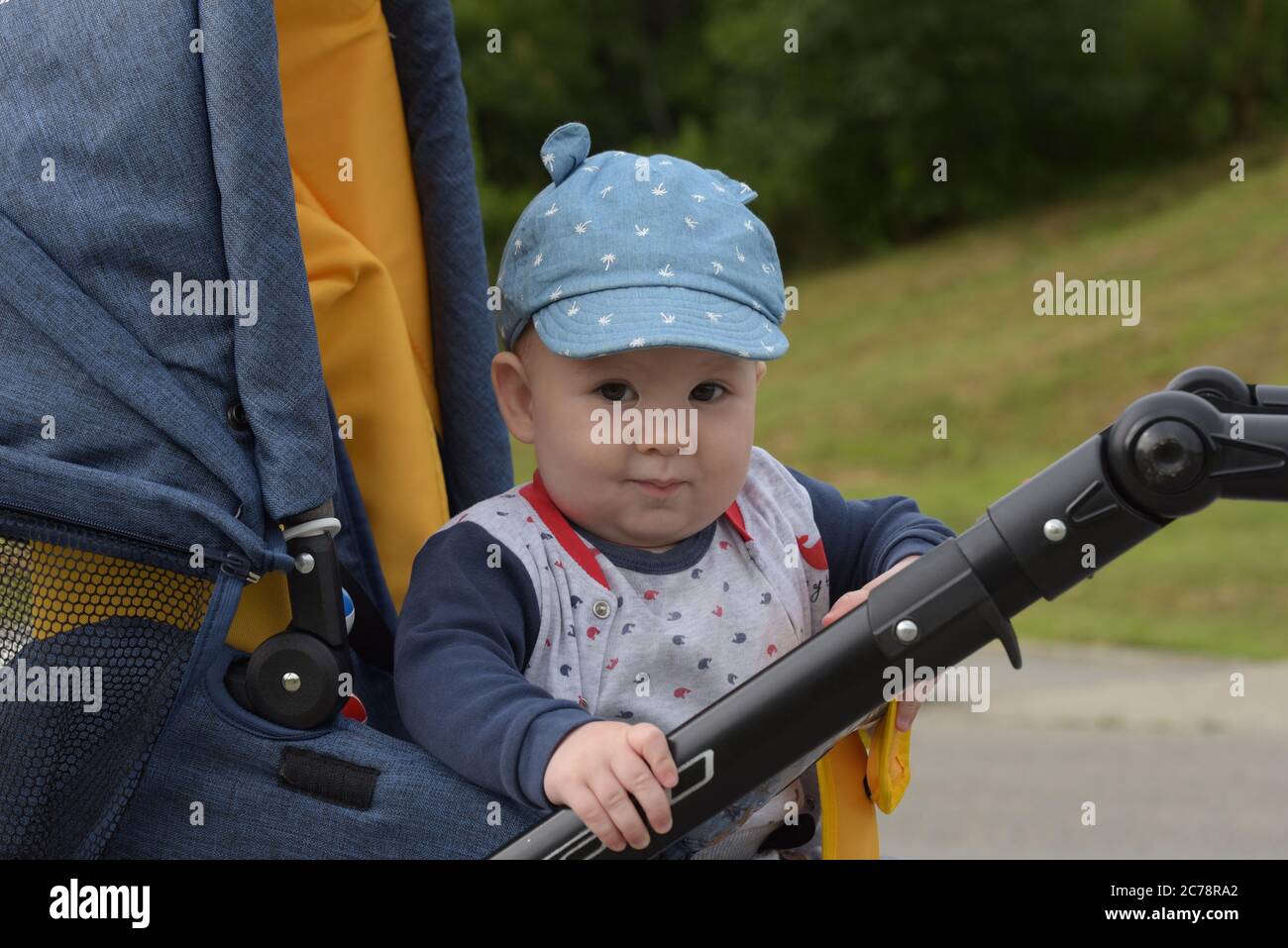Baby sitting in stroller. Face of little boy Stock Photo - Alamy