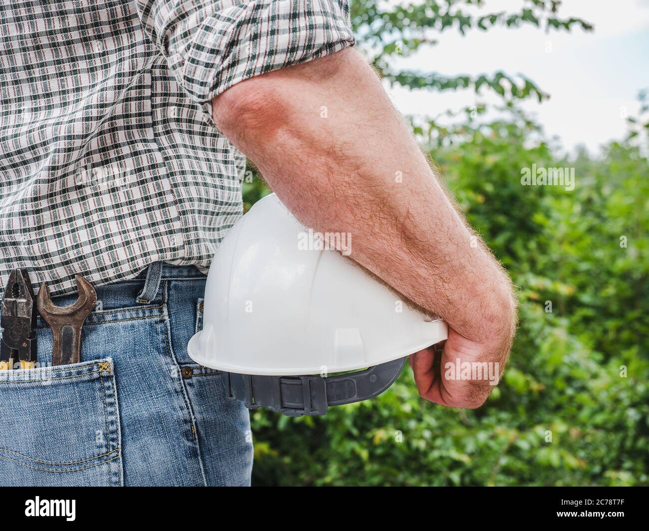 Man with tools, holding a safety helmet Stock Photo - Alamy