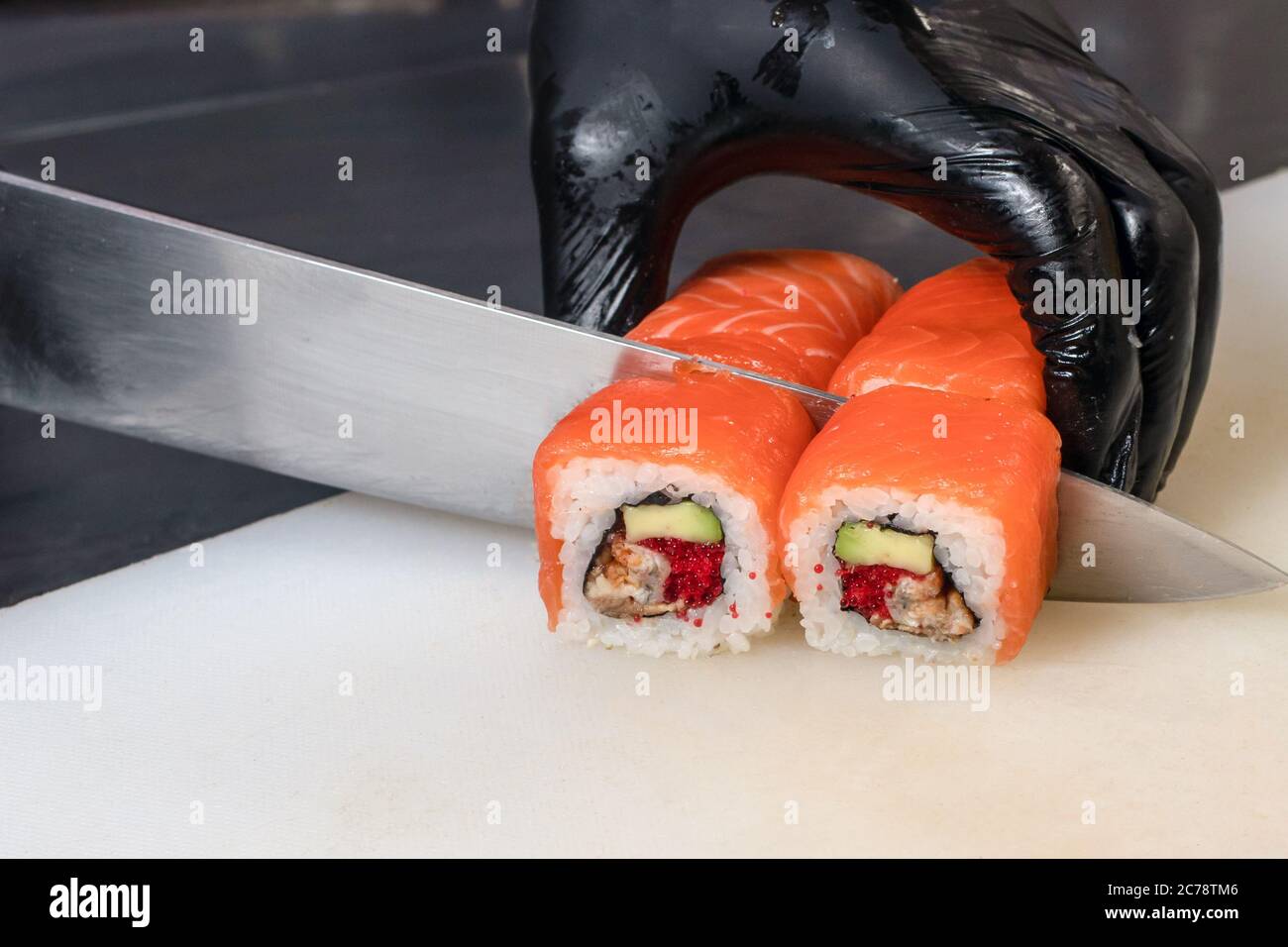 Cut the sushi into pieces. Rolls, cooking. Japanese cuisine Stock Photo ...