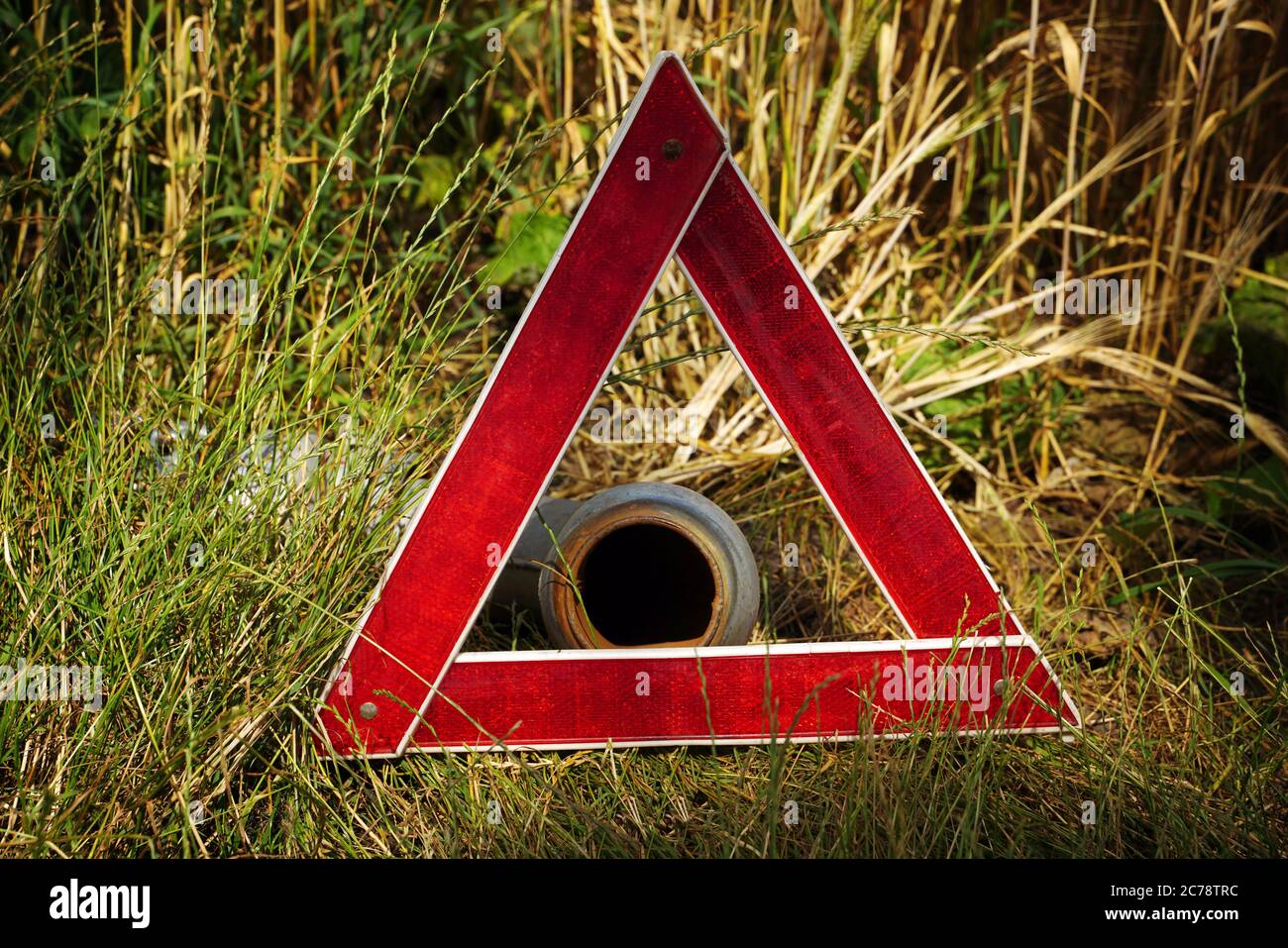Warning triangle in front of a water pipe Stock Photo - Alamy