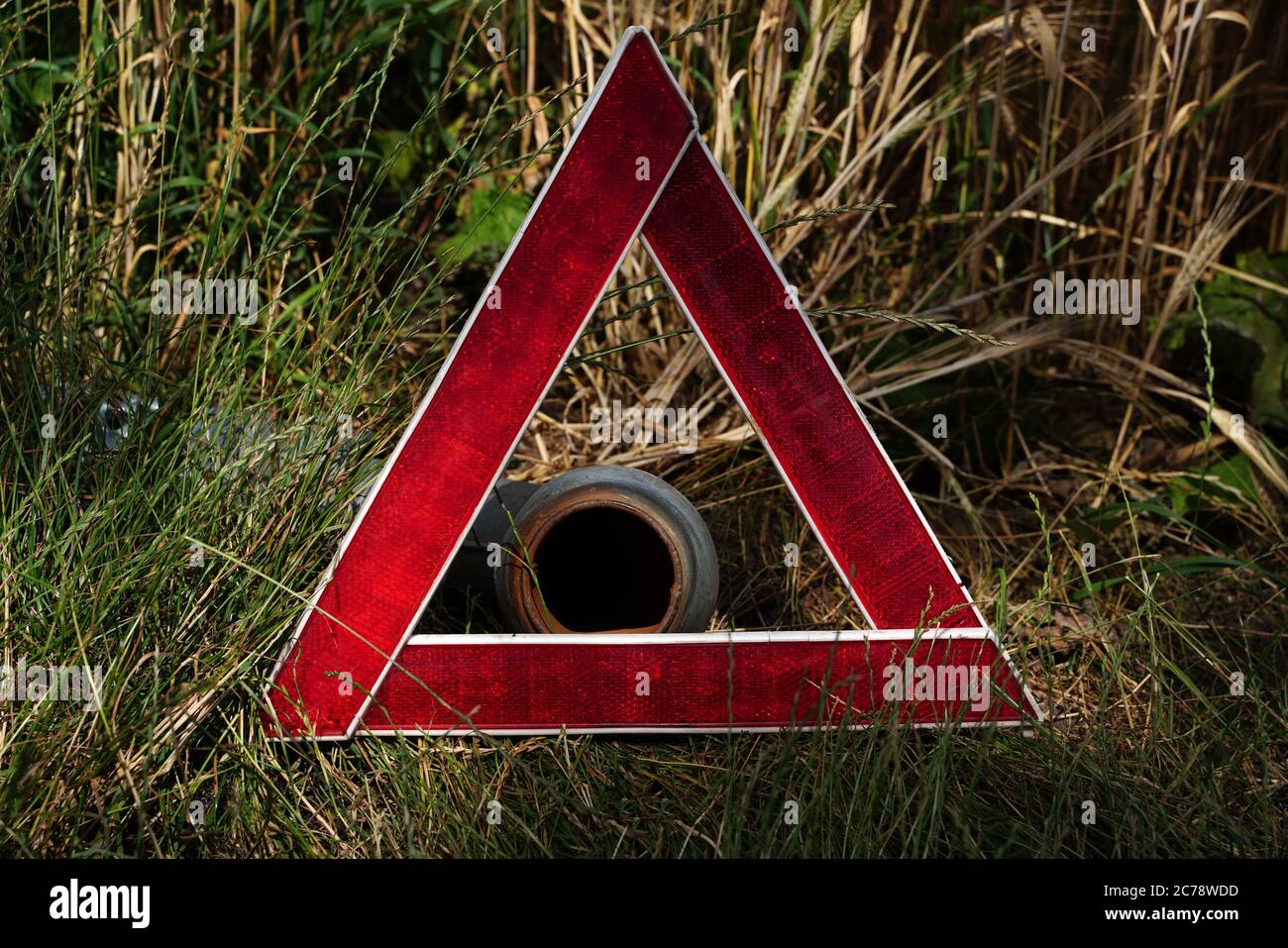 Warning triangle in front of a water pipe Stock Photo - Alamy