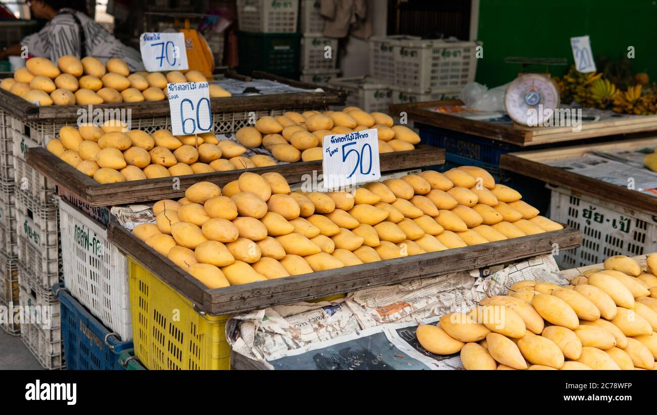 selling fresh mangoes in a market in Asia. Mango is the most popular ...