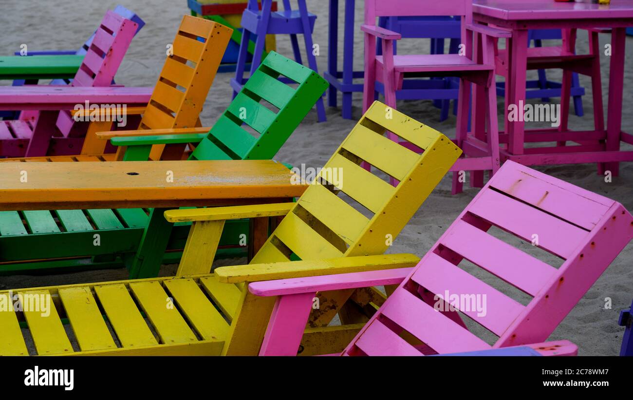Colorful beach chairs in row, Placencia Peninsula, Belize Stock Photo ...