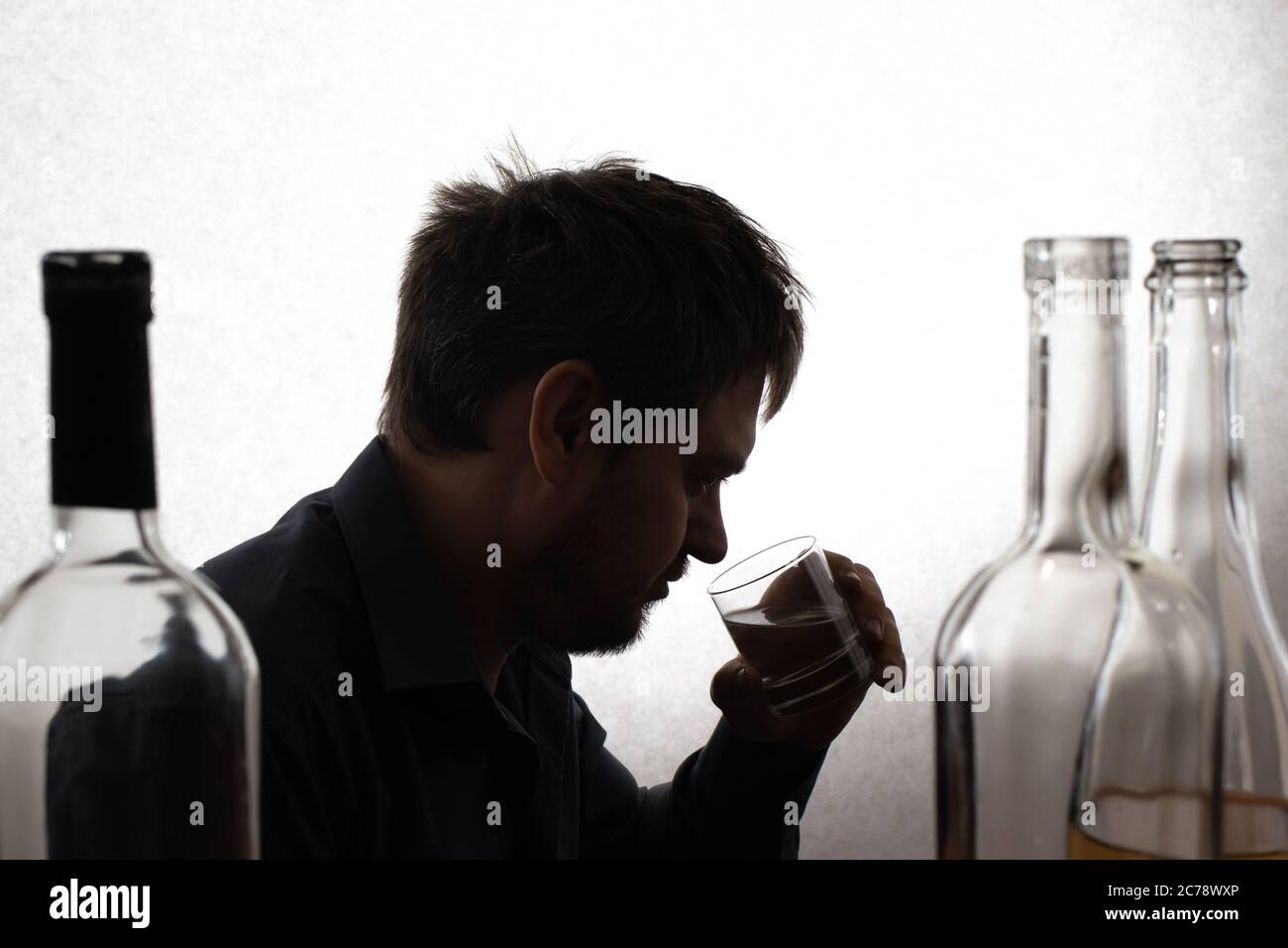 A man and a glass of vodka. Alcoholism, alcohol addiction, delirium ...