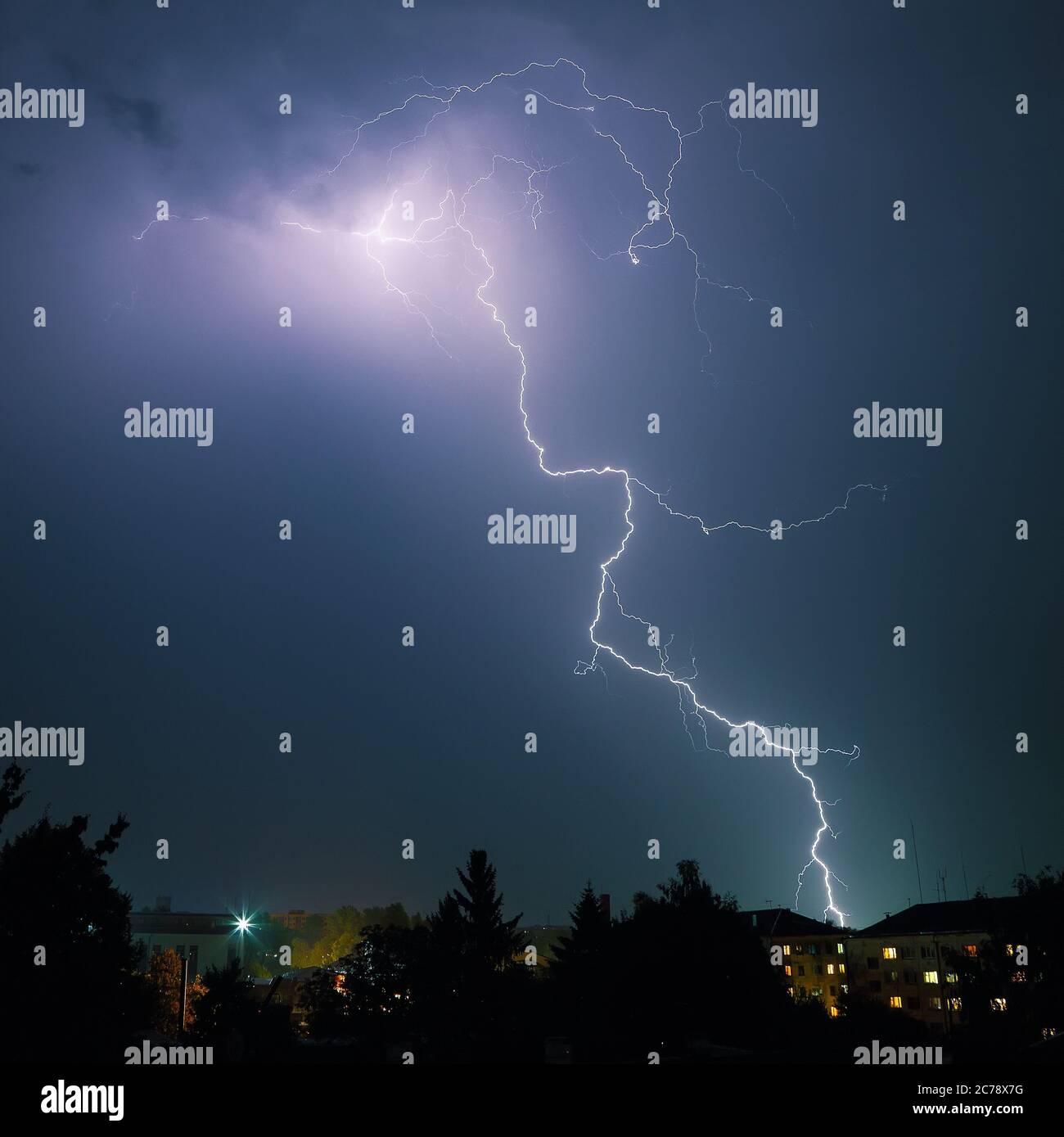 Lightning over the city. Powerfull flash at night Stock Photo - Alamy