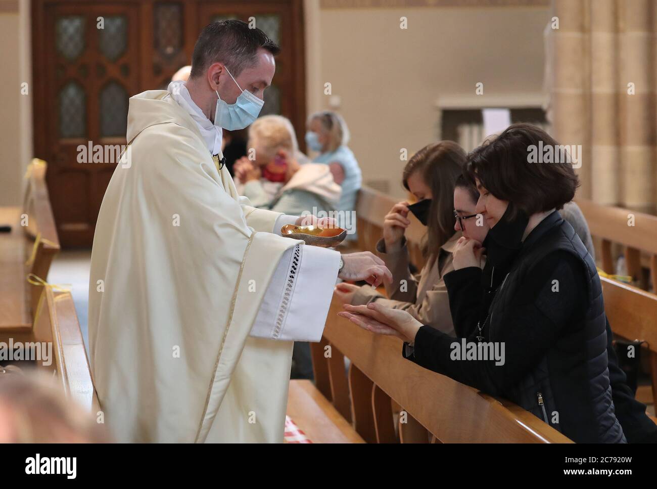Canon Gerald Sharkey during Comunion at the first mass held at St ...