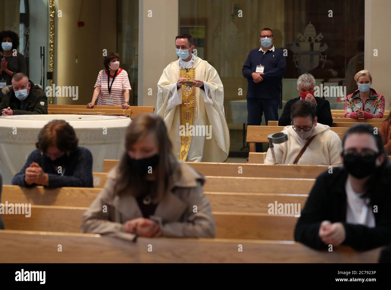 Canon Gerald Sharkey during Comunion at the first mass held at St ...