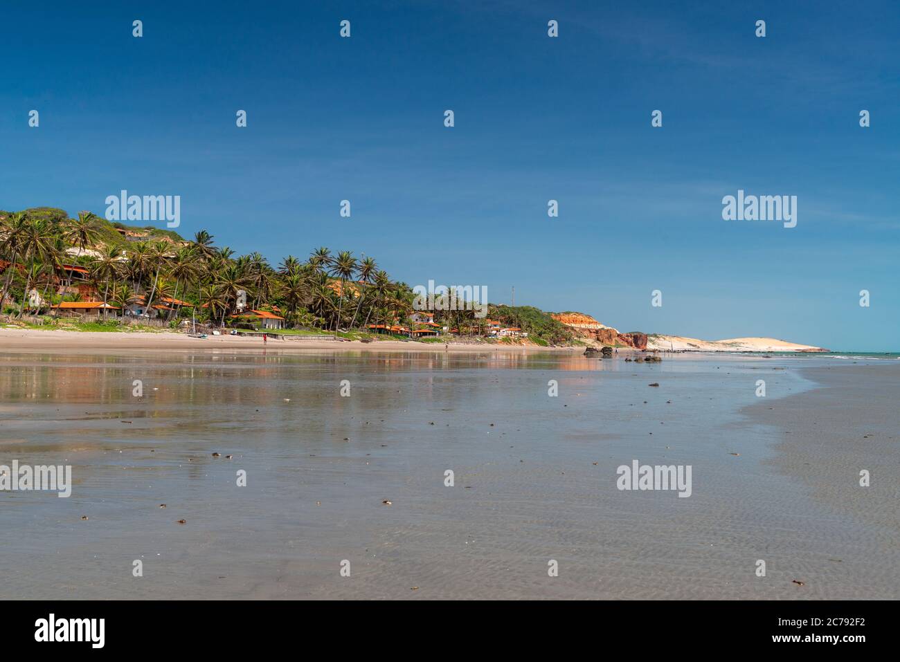 Colored stones and sand on the beach, in the background cliffs with ...