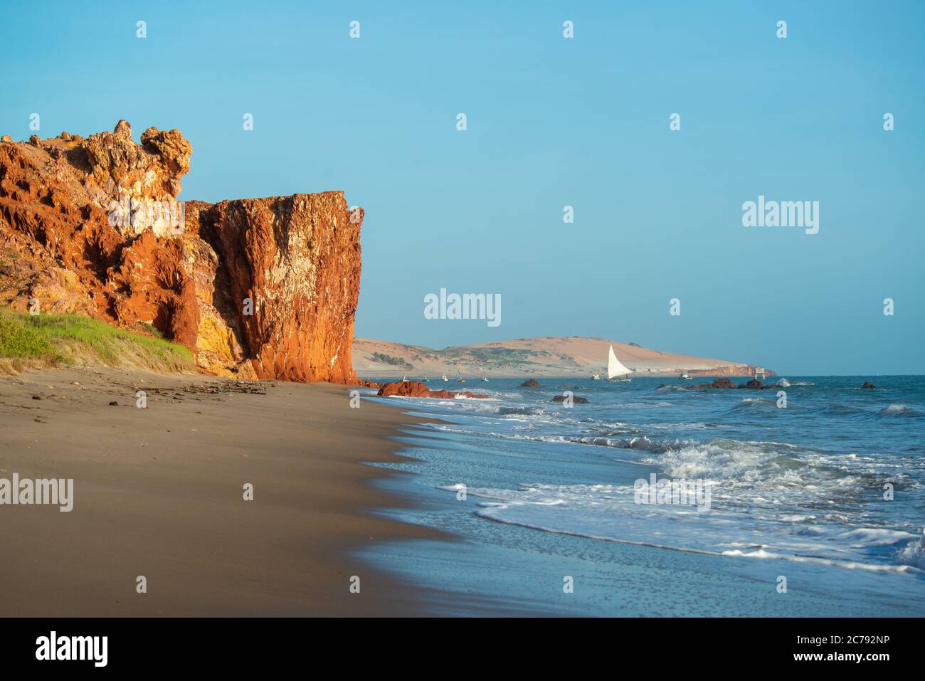 Colorful cliffs, dunes and small sailing boat early morning on the ...