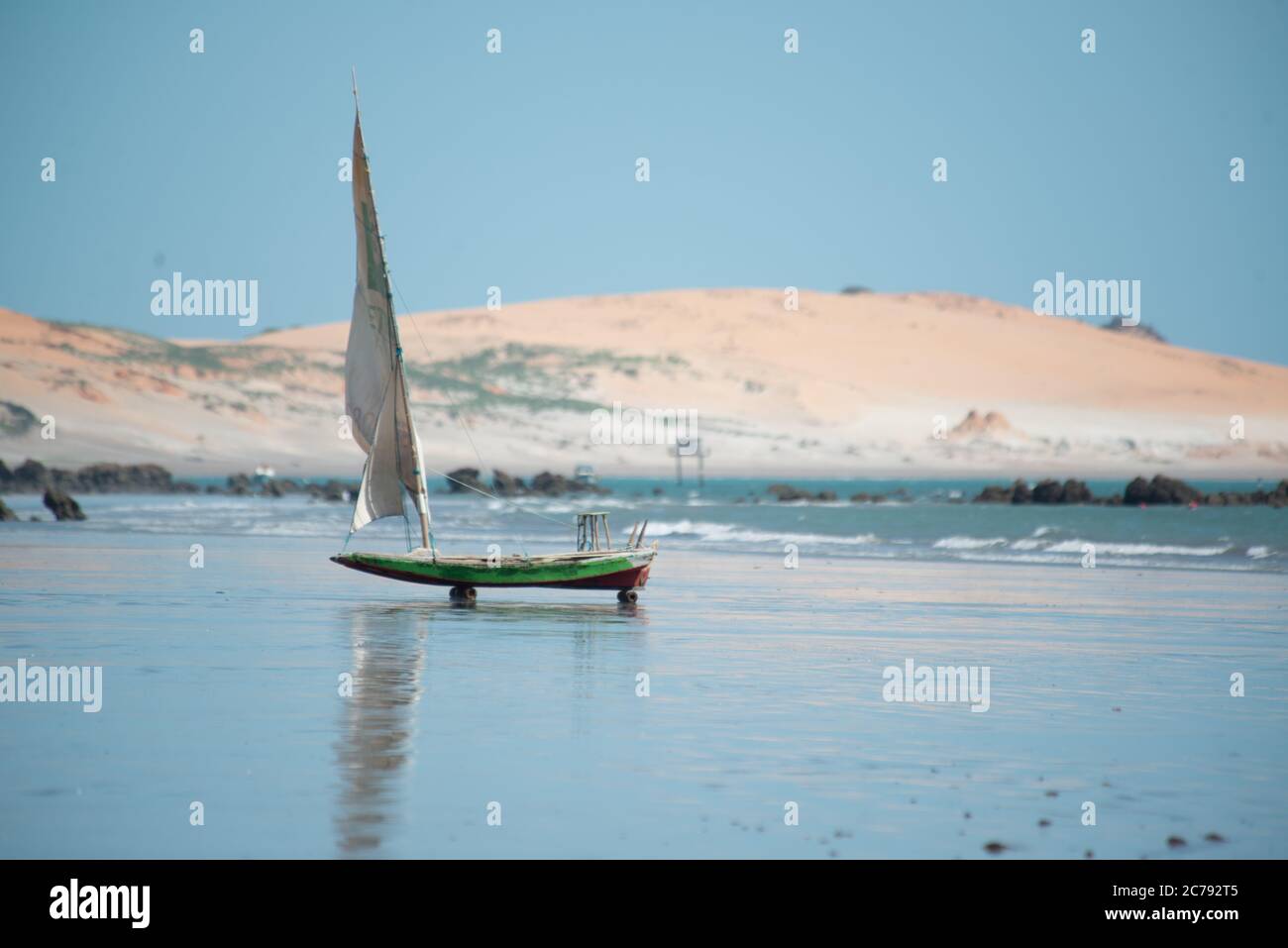 Colorful cliffs, dunes and small sailing boat early morning on the ...