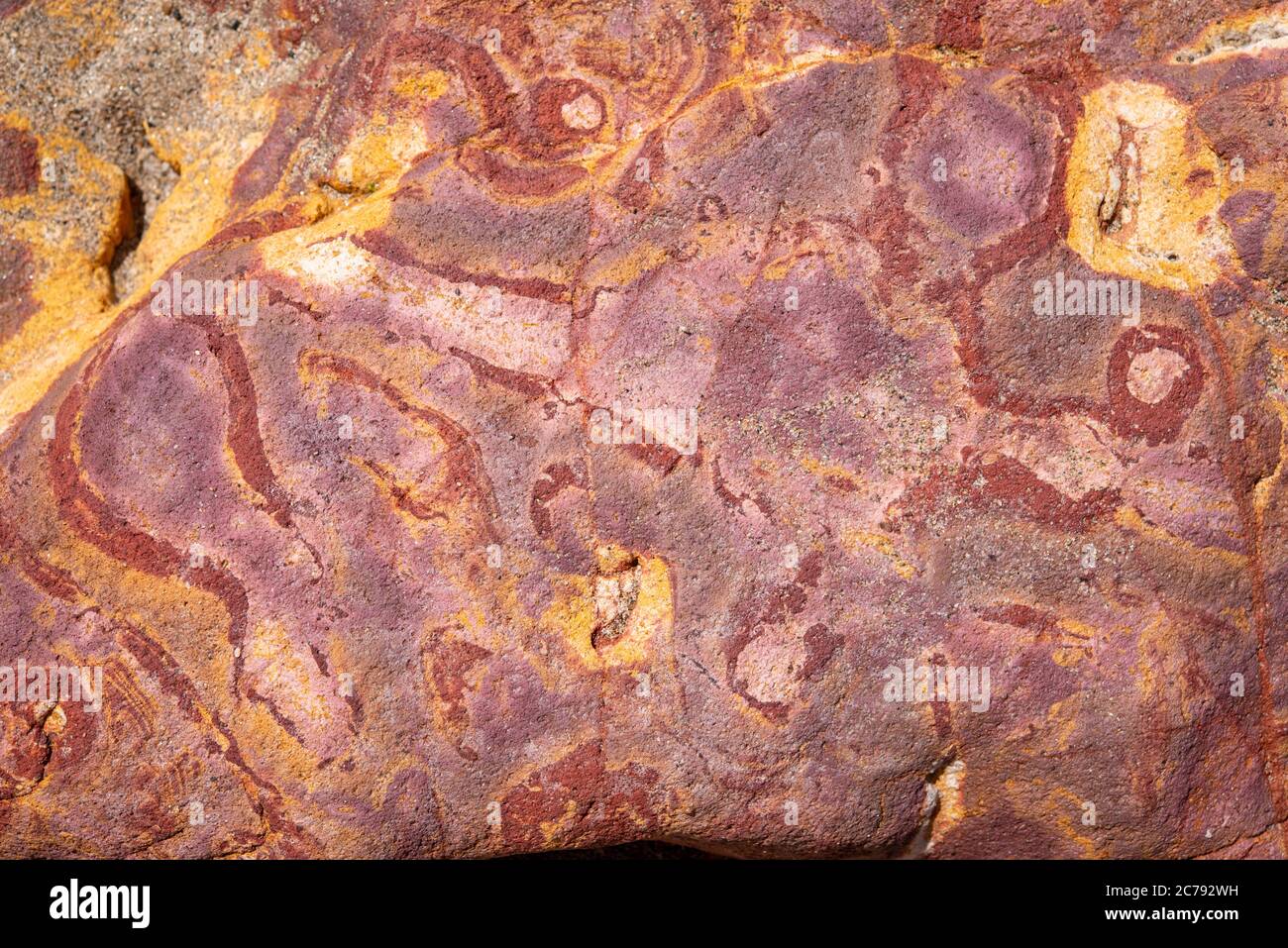 Colorful sand and sedimentary rocks, creating abstract patterns on the ...