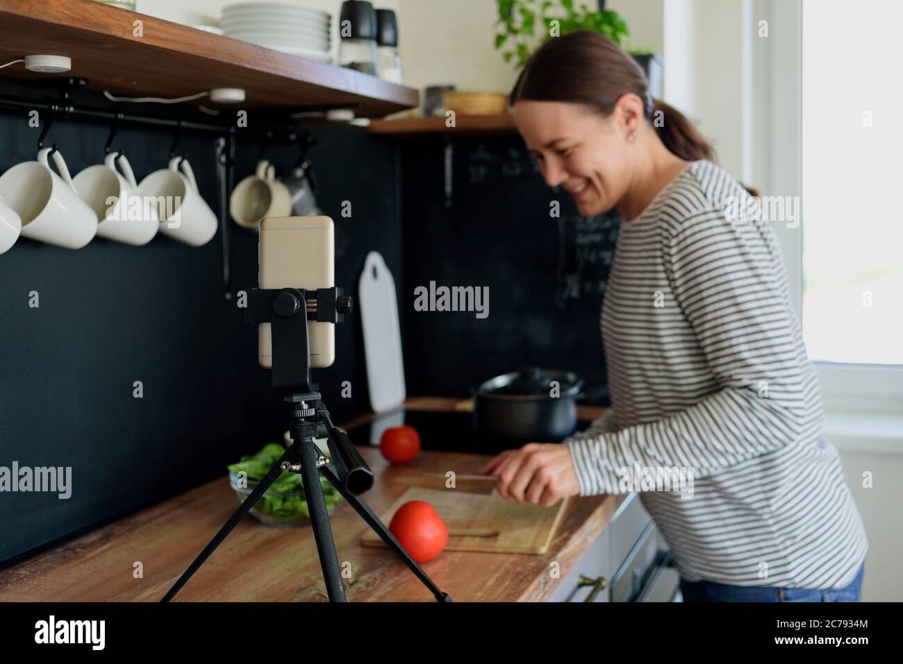 Woman cooking and online video streaming. Vlogger, food blogger Stock ...