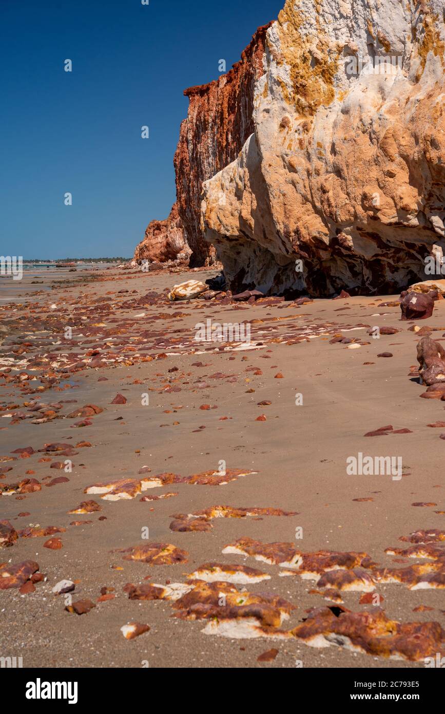 Colorful sand and sedimentary rocks, creating abstract patterns on the ...