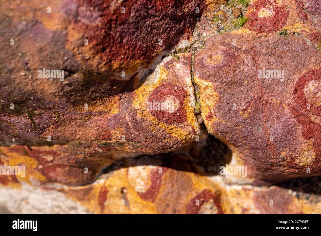 Colorful sand and sedimentary rocks, creating abstract patterns on the ...