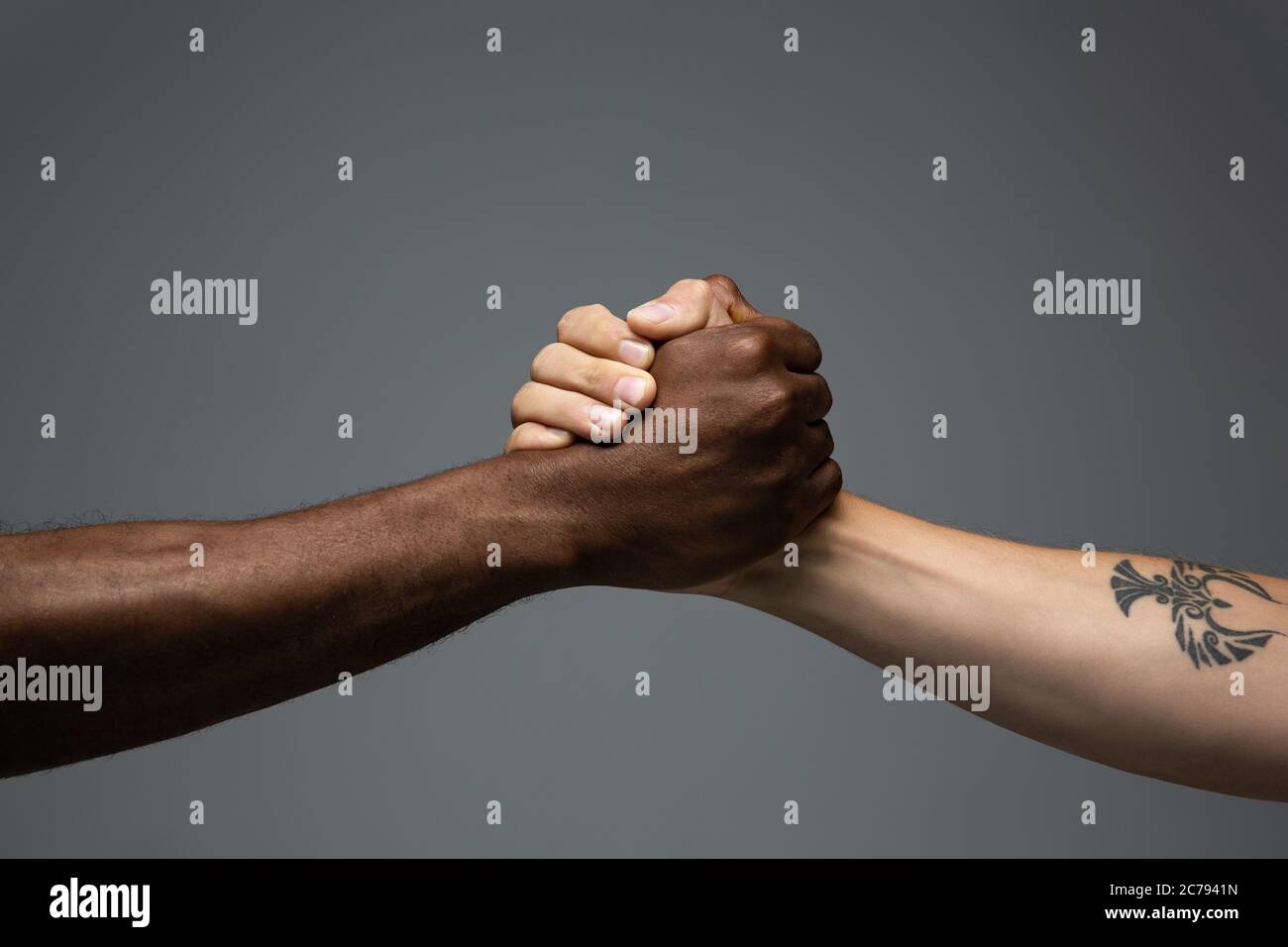 Teamwork. Racial tolerance. Respect social unity. African and caucasian ...