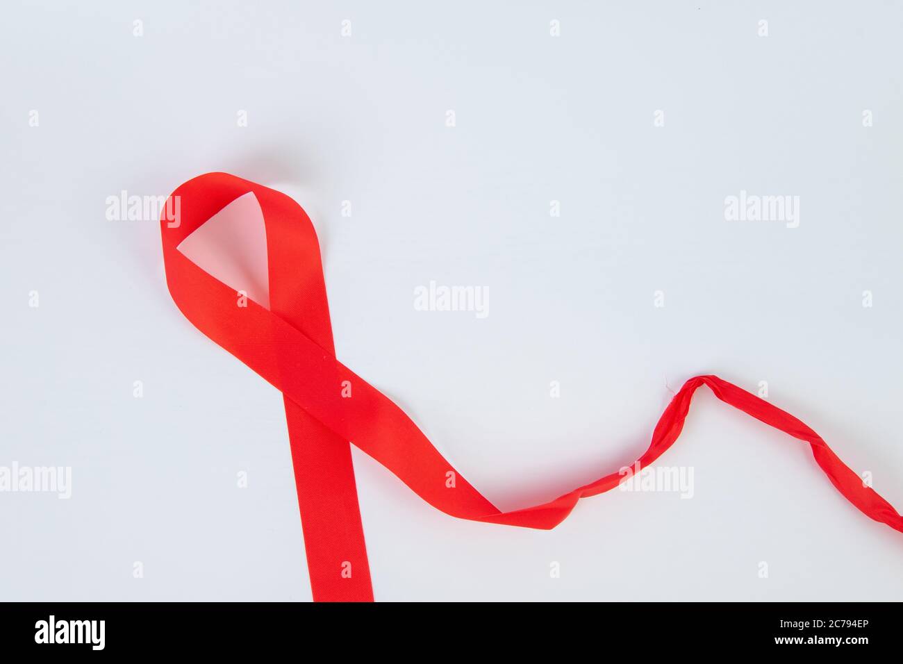 Aids awareness red ribbon isolated on white background Stock Photo - Alamy