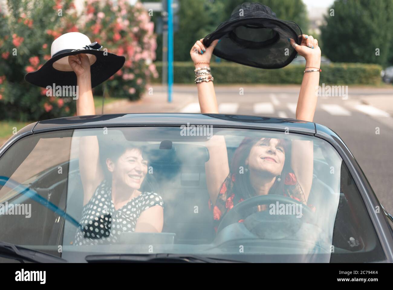 Two female friends on road trip sunset hi-res stock photography and ...