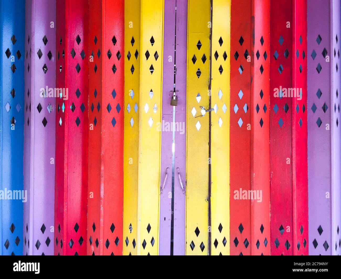 Front view of a colorful collapsible metal door used by shophouses in ...