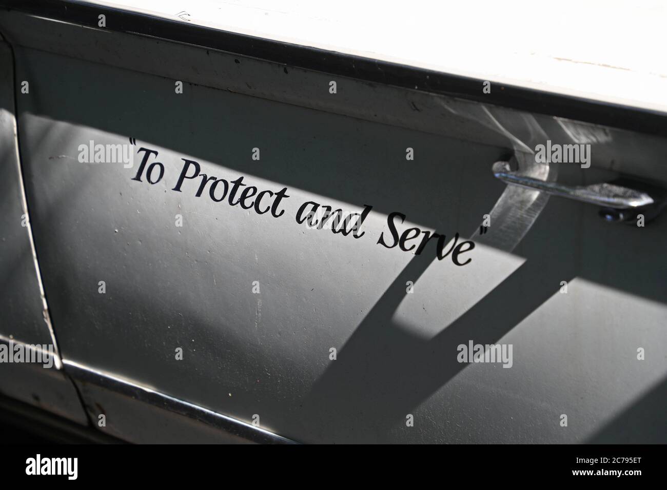 An old American police car. With the text "To protect and to serve ...