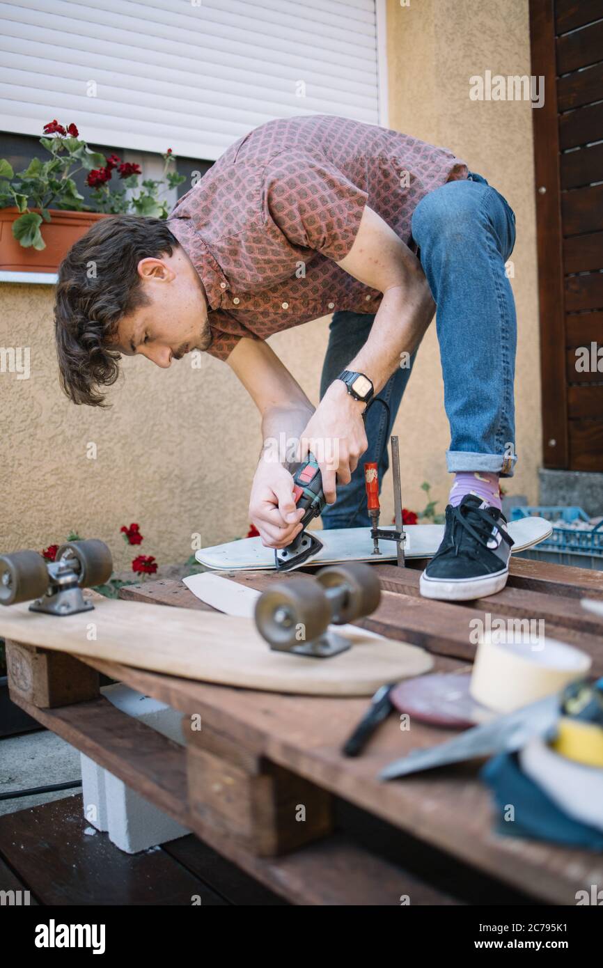 Man processing wooden board with sanding machine Stock Photo - Alamy