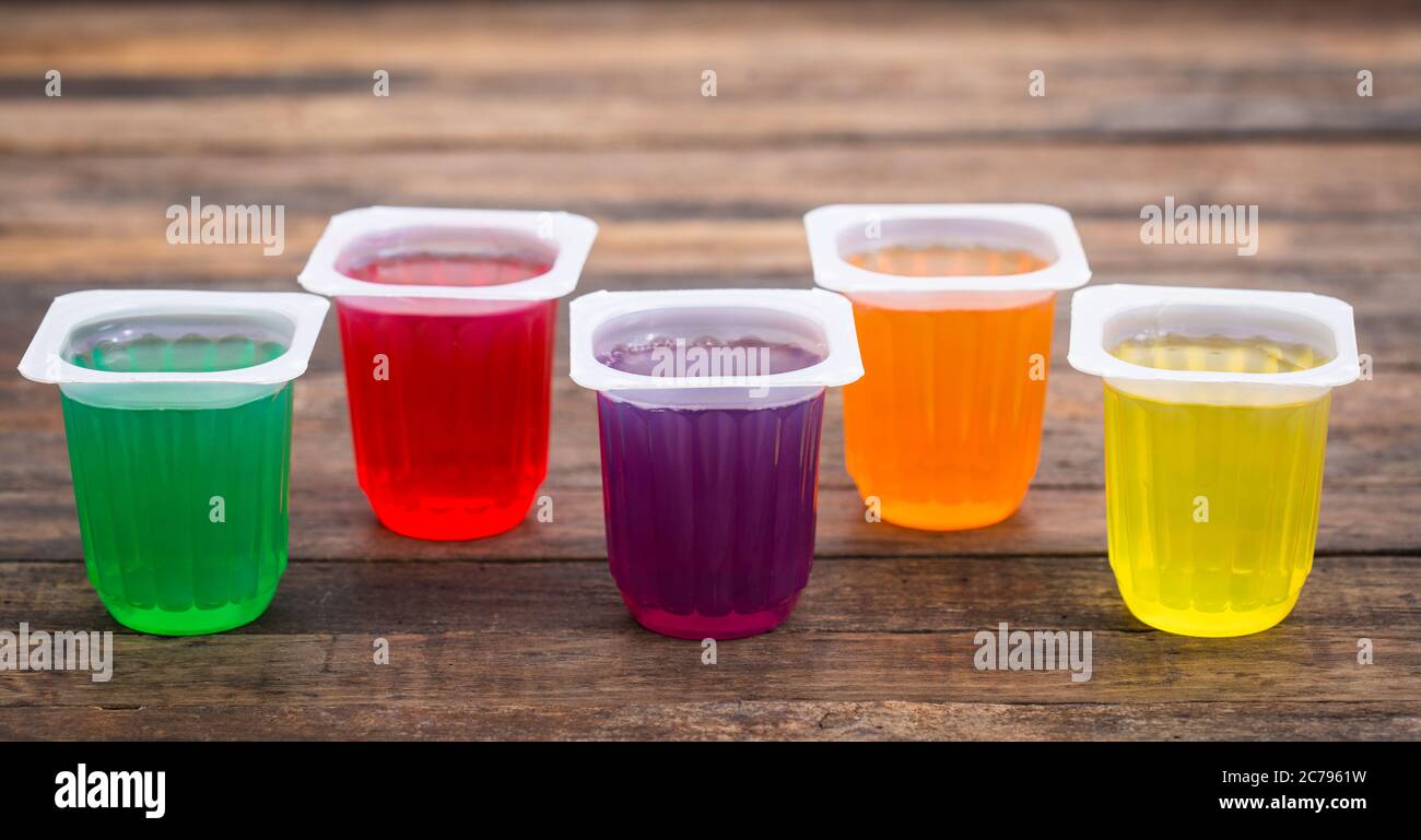 Multi Coloured fruit jelly in the plastic cups Stock Photo - Alamy