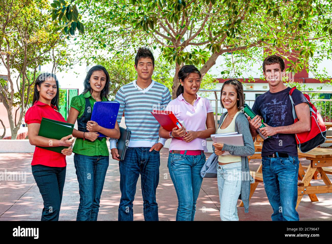 Multicultural Teenagers School group outdoors with study work folders ...
