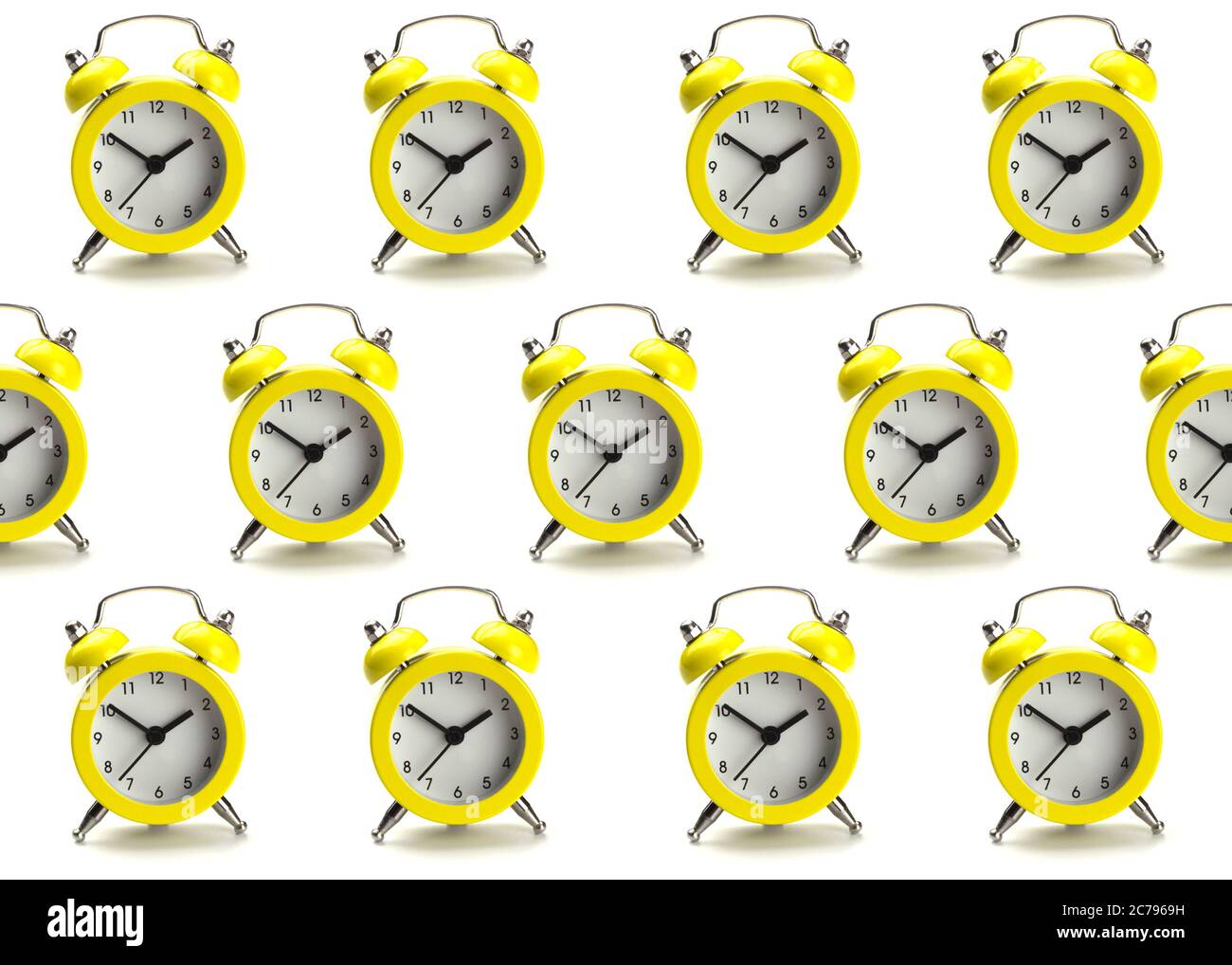yellow alarm clock pattern on a white background Stock Photo - Alamy