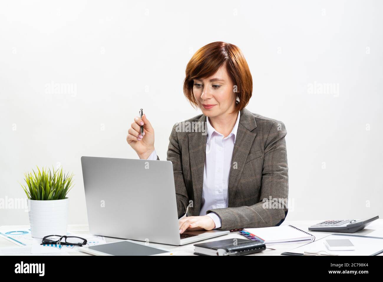Attractive middle aged businesswoman working Stock Photo - Alamy