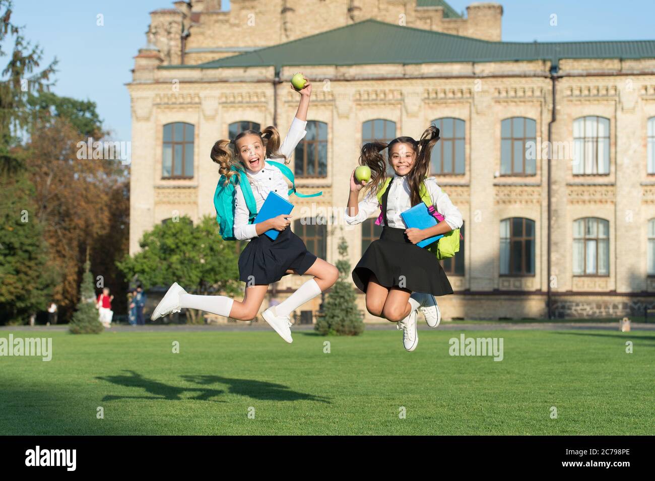 Driven and energetic. Energetic children in midair outdoors. School ...