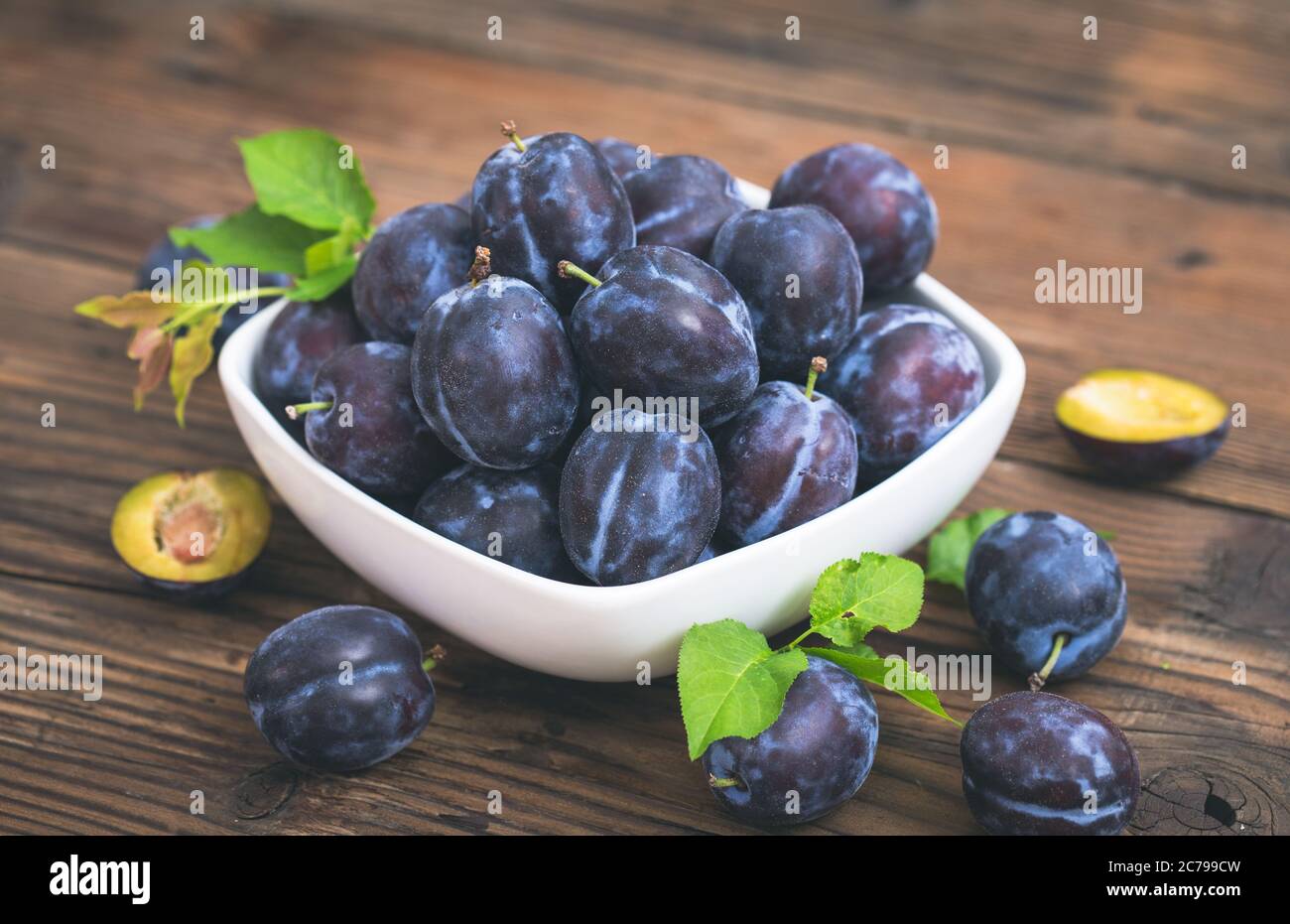 Fresh organic plums in the bowl Stock Photo - Alamy