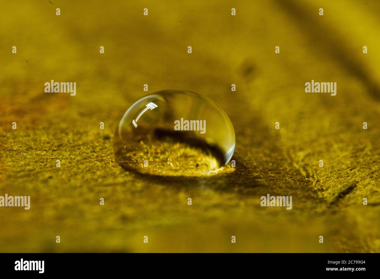 A beautiful closeup photograph of water drop with reflection of lights ...