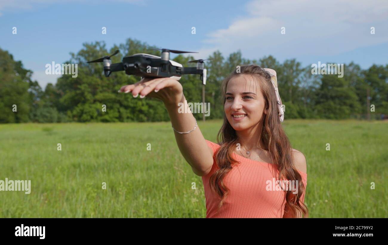 A beautiful girl launches a drone in her palm Stock Photo - Alamy